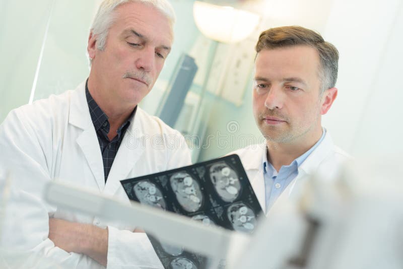 Portrait Doctors Looking at Xrays Stock Image - Image of years, worker ...