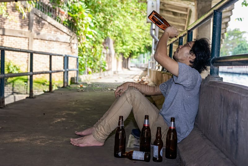 Portrait of a Drunkard Sitting Looking at the Empty Bottles of Liquor ...