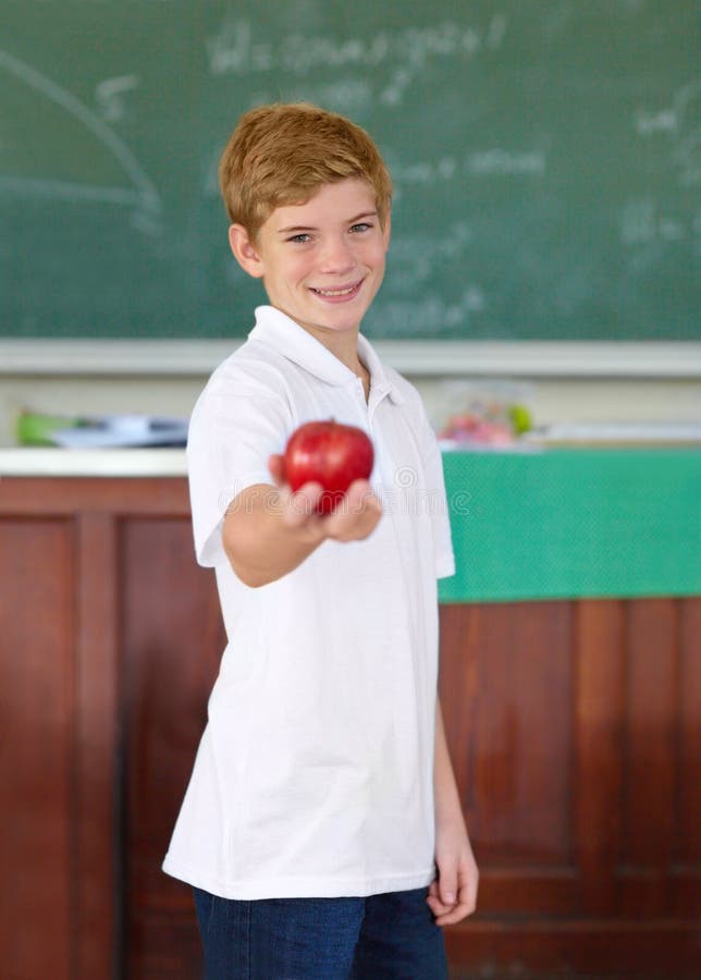 Portrait, Education and Apple with a Boy Student in a Classroom for ...