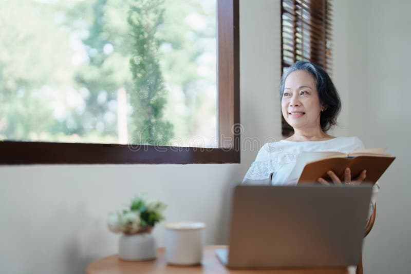 Portrait of an Elderly Asian Woman in a Modern Pose Holding a Memory ...