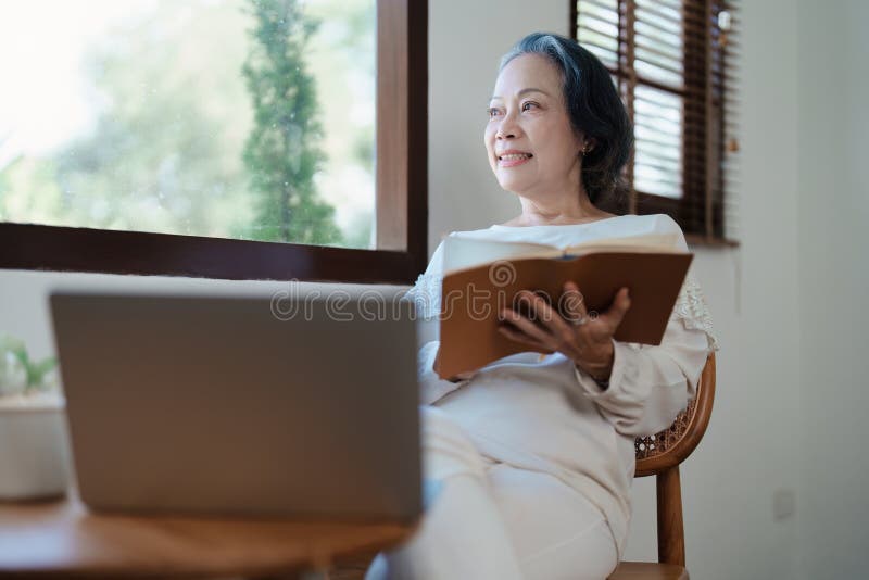 Portrait of an Elderly Asian Woman in a Modern Pose Holding a Memory ...
