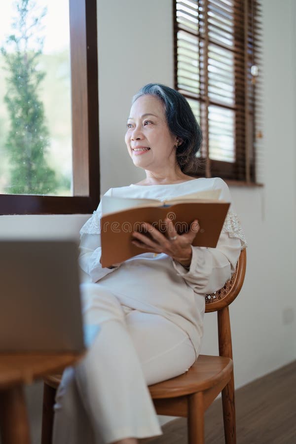 Portrait of an Elderly Asian Woman in a Modern Pose Holding a Memory ...