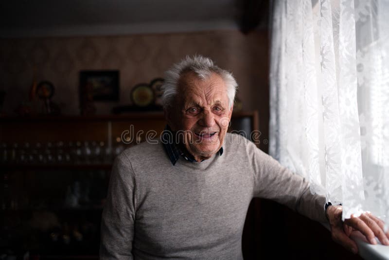 Portrait of Elderly Man Standing Indoors at Home, Looking at Camera and ...