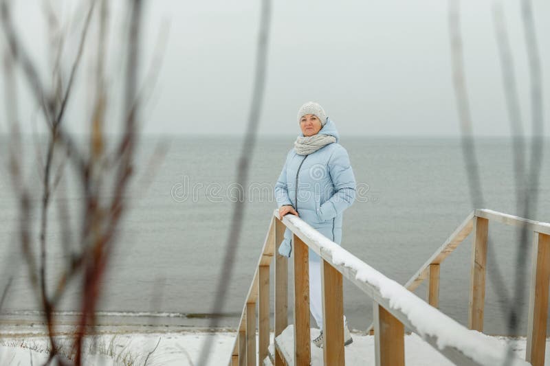 Portrait of an Elderly Woman Standing Outdoors by the Sea Stock Photo ...