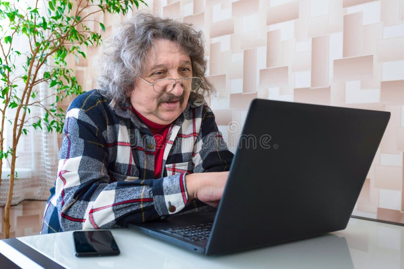 A Portrait of an Elderly 60 or 70-year Old Man Working at the Computer ...