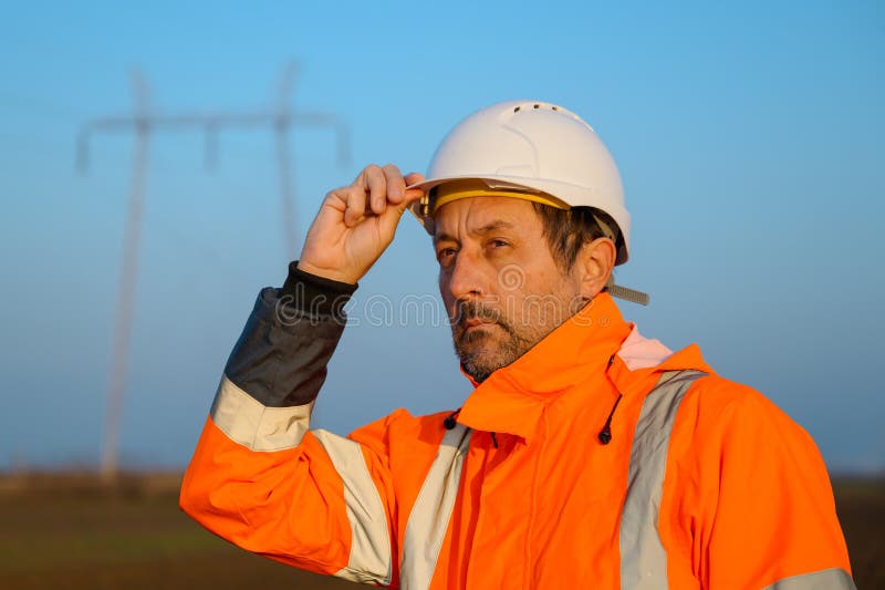 Portrait of Electrical Engineer in Field Wearing High Visibility Jacket ...