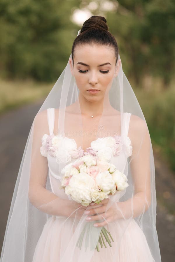 Portrait of Elegand Bride with Bouquet. Young Bride Outdoors Stock ...