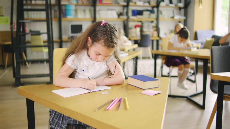Portrait of an Elementary School Student Sitting at the Front Desk ...