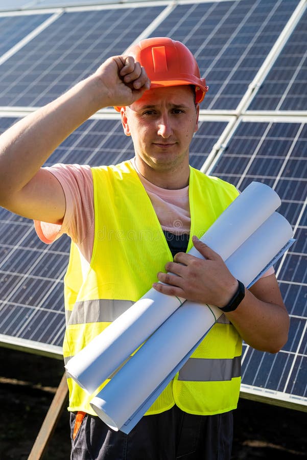 Portrait of Engineer with Blueprints Posing Against Solar Panels Stock ...