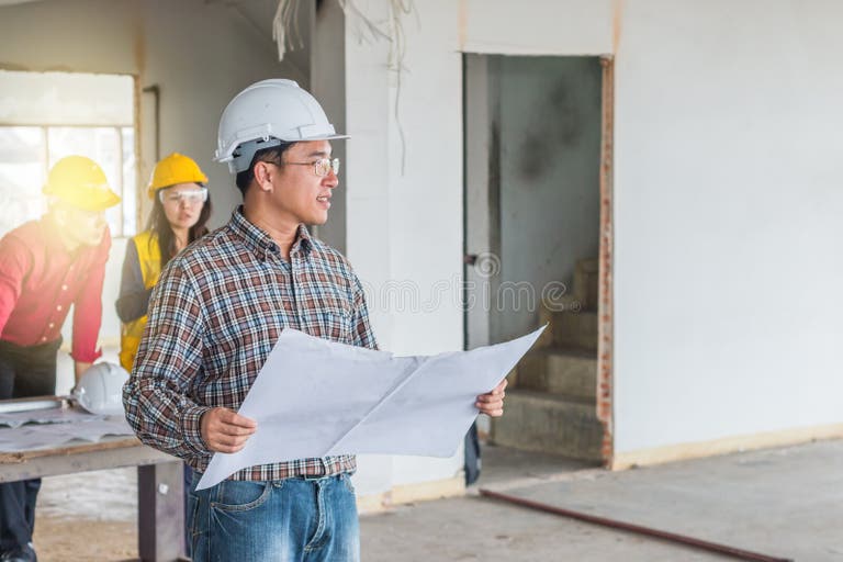 Portrait of Engineer Checking the Blueprint with Commitment To Success ...