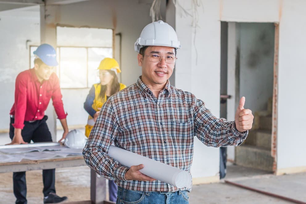 Portrait of Engineer Checking the Blueprint with Commitment To Success ...