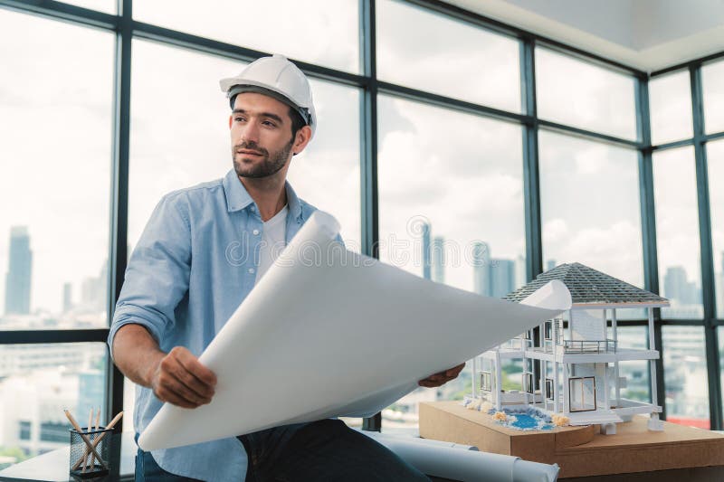 Portrait of Engineer Looking at Camera while Reading Project Plan ...