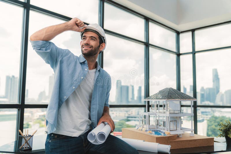 Portrait of Engineer Looking at Camera while Reading Project Plan ...