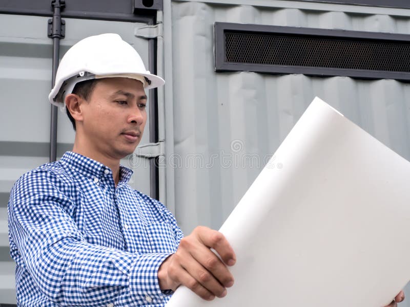 Portrait of an Engineer Man with Helmet Looking Paper Plans at ...