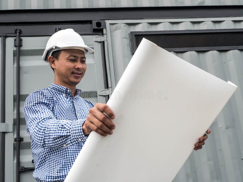 Portrait of an Engineer Man with Helmet Looking Paper Plans at ...
