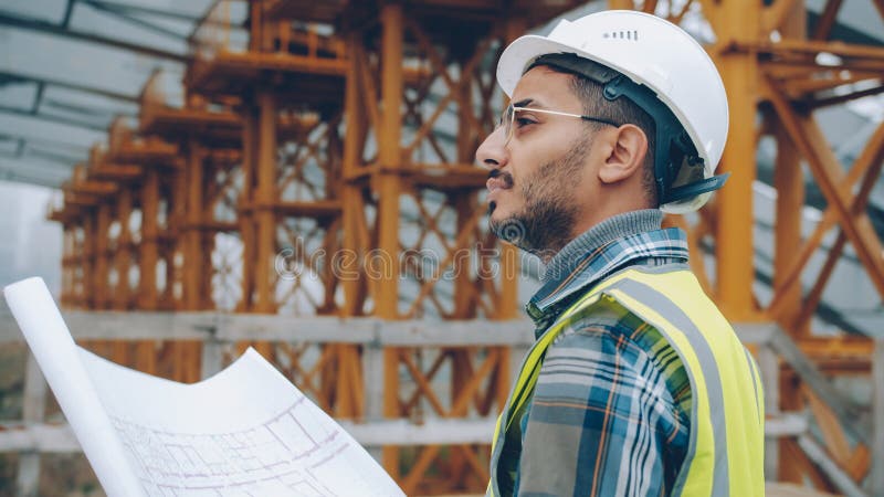 Portrait of Engineer Planning Work at Construction Site Looking at ...