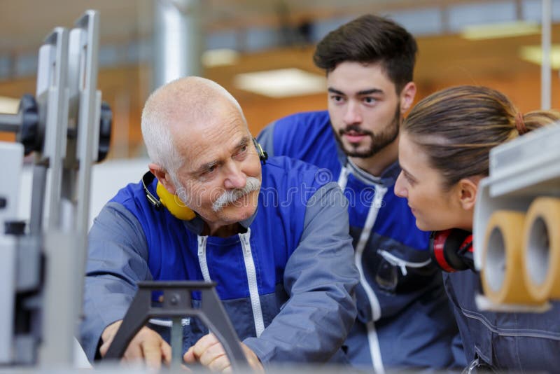 Portrait Engineers and Apprentices in Busy Factory Stock Photo - Image ...