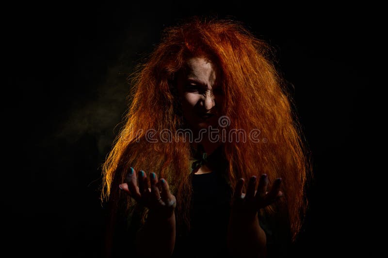 Portrait of an Evil Red-haired Witch Conjures in the Dark. Stock Image ...
