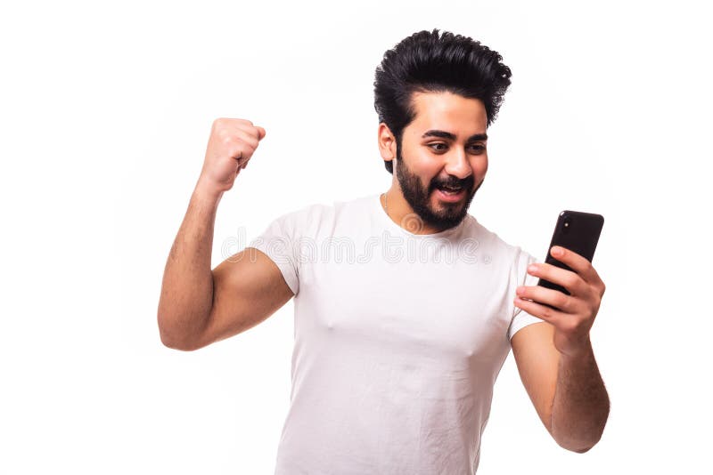 Portrait of an Excited Young Arab Man Celebrating Looking at Mobile ... Portrait of an Excited Young Arab Man Celebrating Looking at Mobile ...