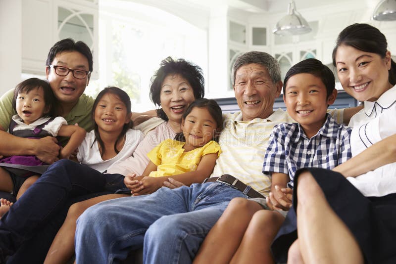 Portrait of Extended Family Group Sitting at Home on Sofa Stock Photo ...