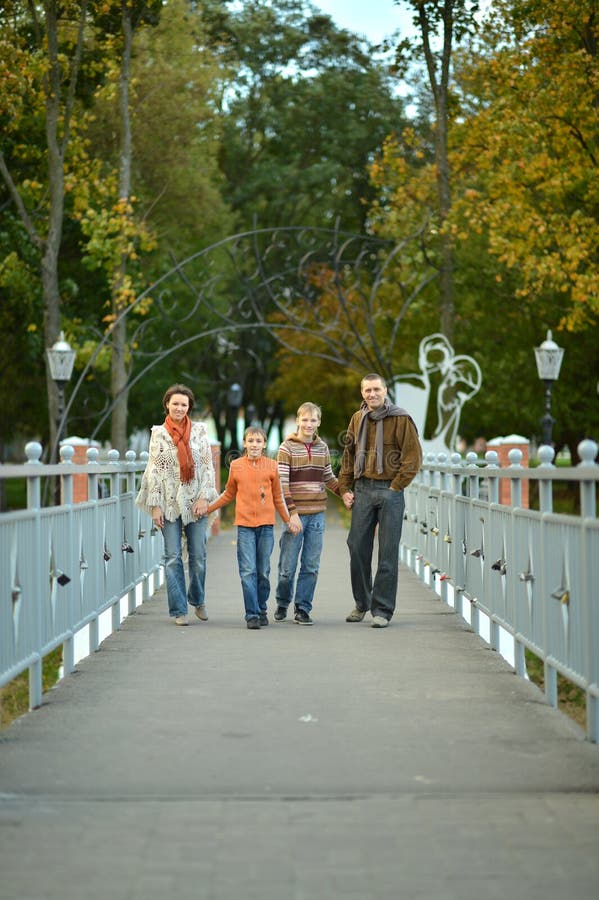 Portrait of Family of Four Posing on Bridge Stock Image - Image of male ...