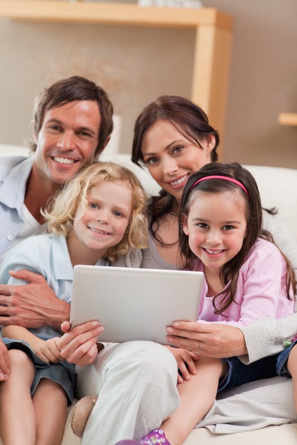 Happy Family Using Tablet Computer at Home Stock Photo - Image of ...