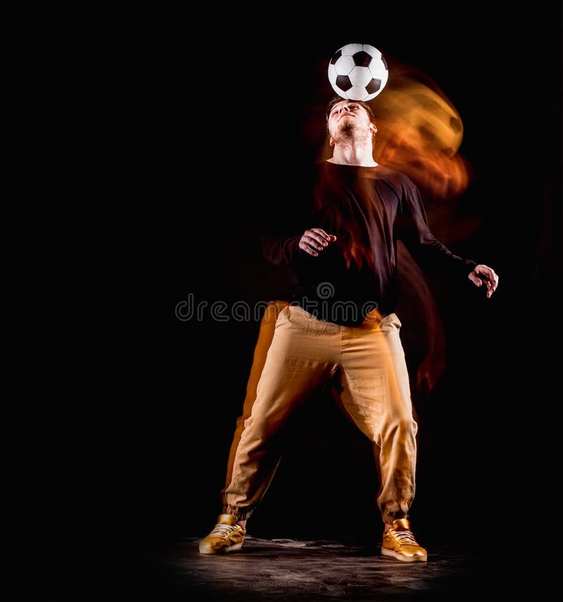 A Portrait of a Fan with Ball on Gray Studio Background. Freestile ...