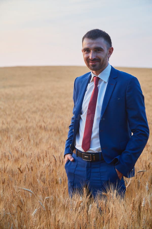 Portrait of a Farmer in a Blue Suit, in a Field of Ripe Wheat Stock ...