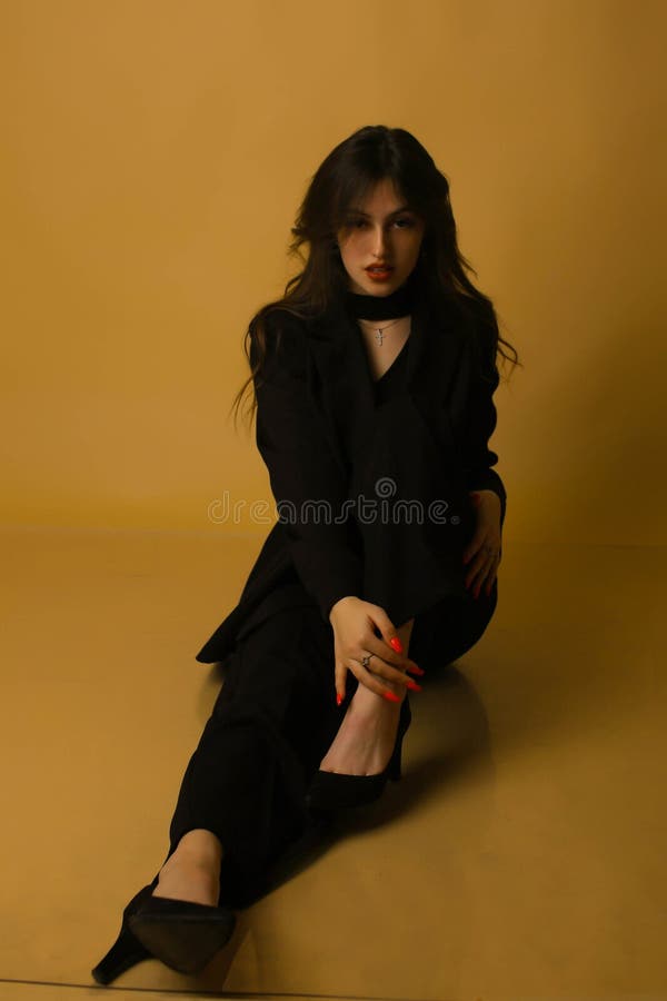 Portrait of a Fashion Model in the Studio Dressed in an Elegant Black ...