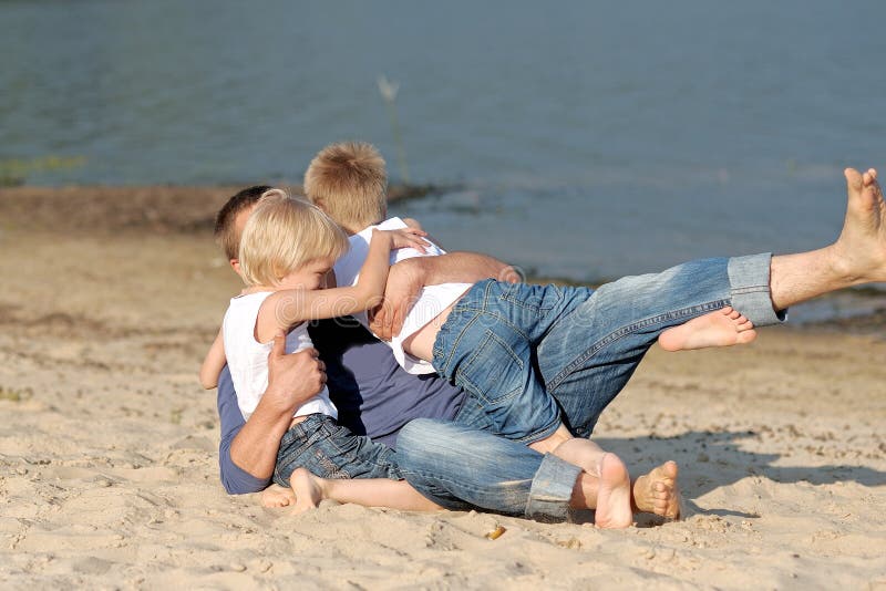 Portrait of a Father and Two Sons Stock Photo - Image of outdoors ...