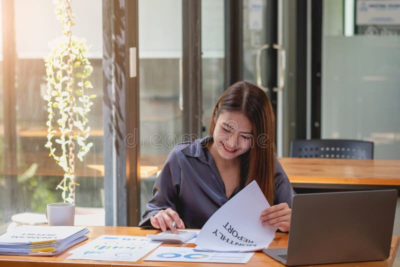 Portrait of a Female Accountant Using a Calculator and Laptop To ... Portrait of a Female Accountant Using a Calculator and Laptop To ...