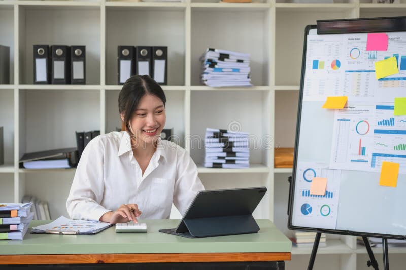 Portrait of a Female Accountant Using a Calculator and Laptop To ... Portrait of a Female Accountant Using a Calculator and Laptop To ...