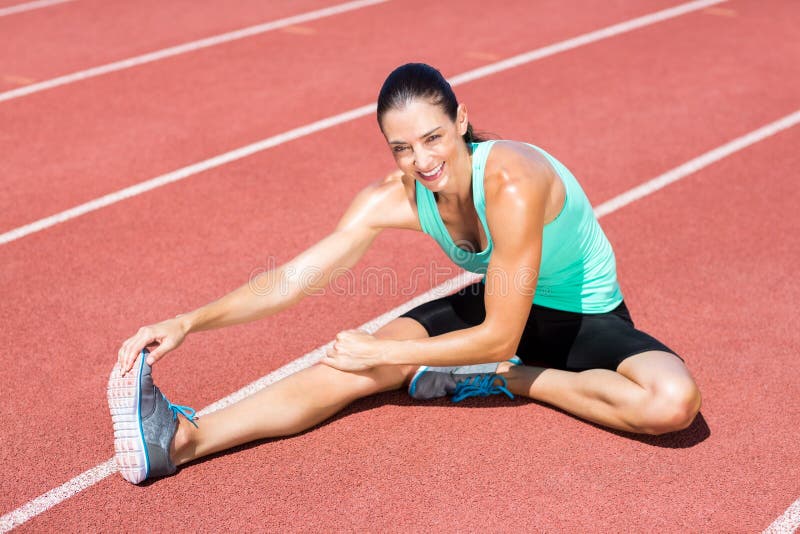 Portrait of Female Athlete Stretching Her Hamstring Stock Photo - Image ...