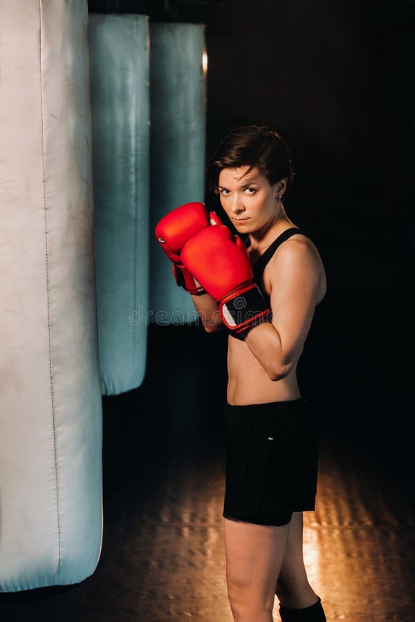 Portrait of a Female Boxer in Red Gloves in the Gym during Training ...