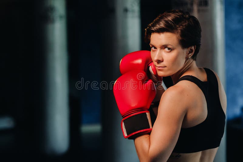 Portrait of a Female Boxer in Red Gloves in the Gym during Training ...