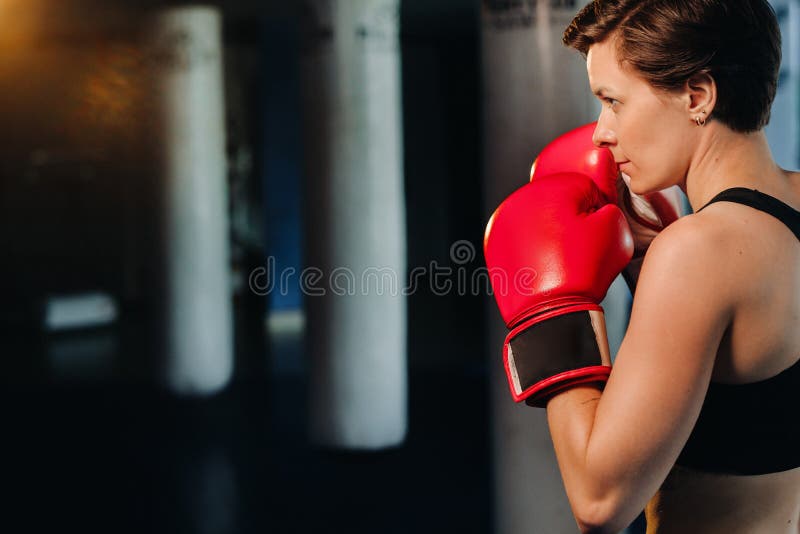 Portrait of a Female Boxer in Red Gloves in the Gym during Training ...