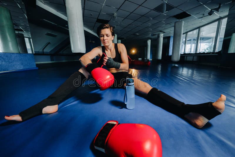 Portrait of a Female Boxer in Red Gloves in the Gym after Training ...