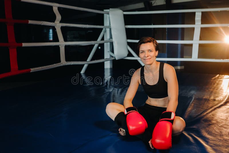 Portrait of a Female Boxer with Red Gloves after Training Sitting in ...