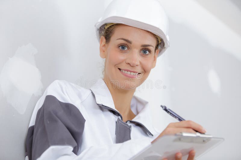 Portrait Female Builder Writing on Clipboard Stock Photo - Image of ...