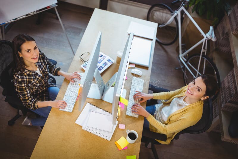 Portrait of Female Colleagues Working at Computer Desk Stock Image ...