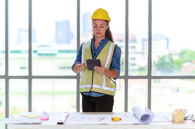 Portrait of Female Construction Engineer Workers in Yellow Hardhat with ...