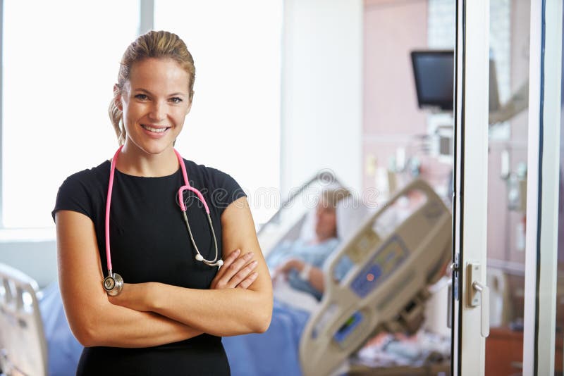 Portrait of Female Doctor with Patient in Background Stock Photo ...