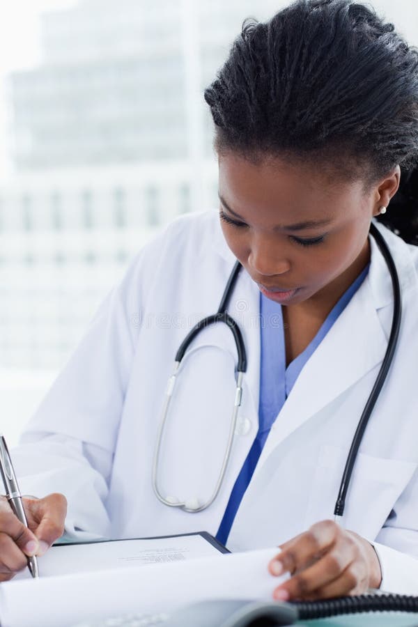 Portrait of a Female Doctor Signing a Document Stock Image - Image of ...