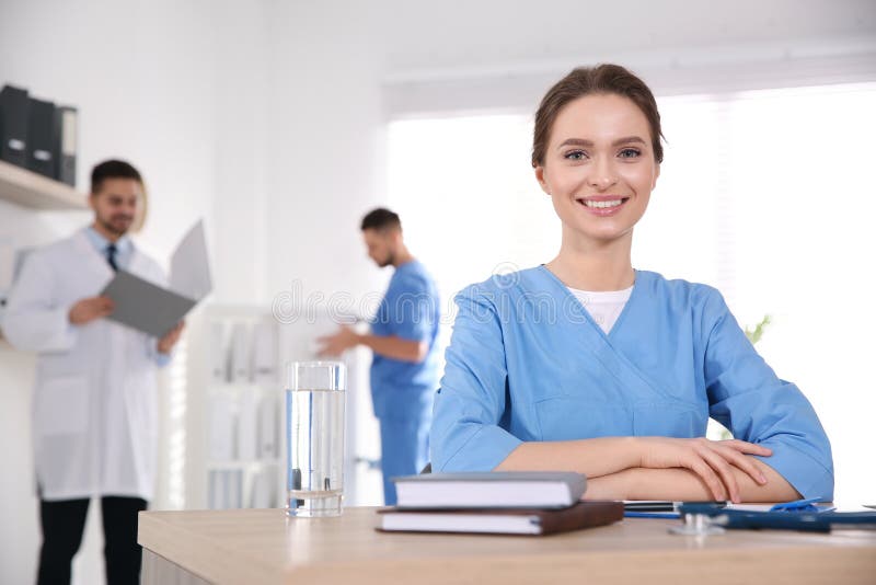 Portrait of Female Doctor at Table in Clinic Stock Image - Image of ...