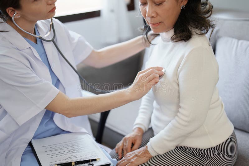 Portrait of a Female Doctor Using a Stethoscope To Check the Pulse of ...
