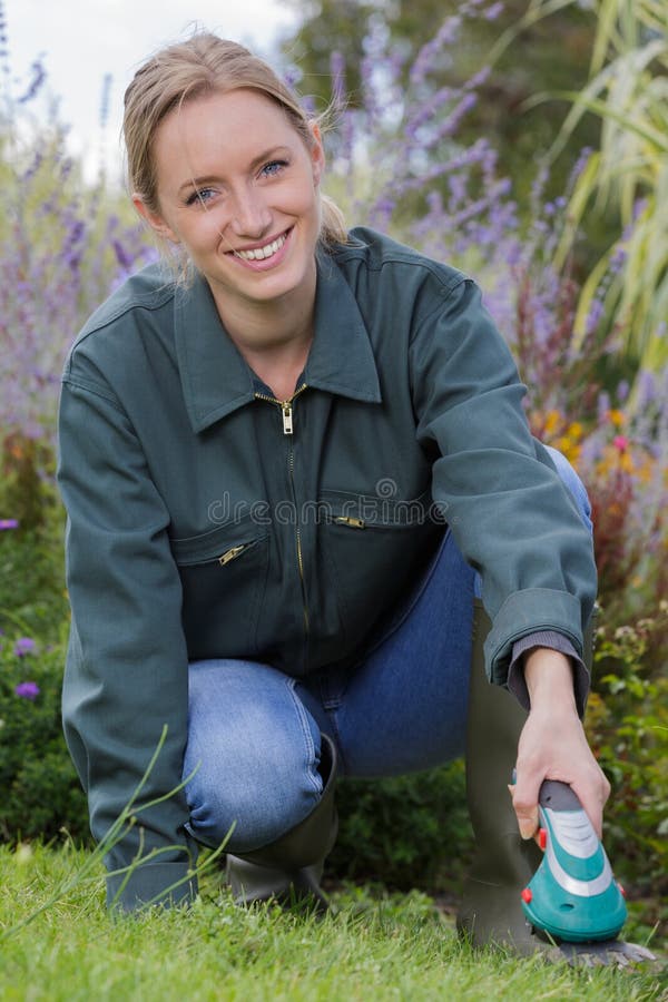 Portrait Female Gardener Using Weeding Tool Stock Photo - Image of farm ...