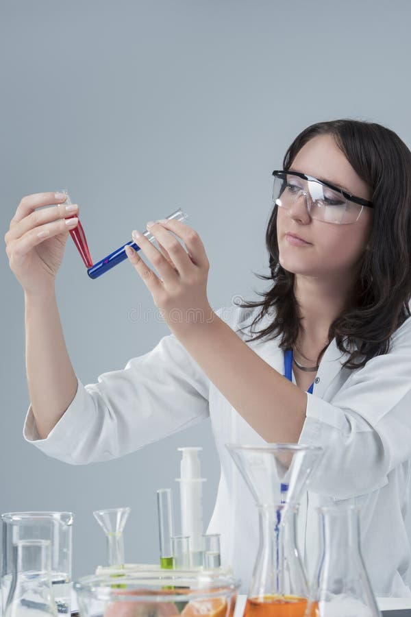 Portrait of Female Laboratory Staff with Two Flasks Samples. Stock ...