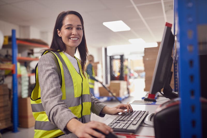 Portrait of Female Manager in Busy Modern Warehouse Working on Computer ...