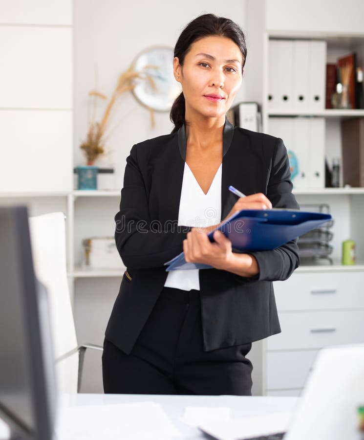 Portrait of Female Manager with Folder of Documents in Office Stock ...