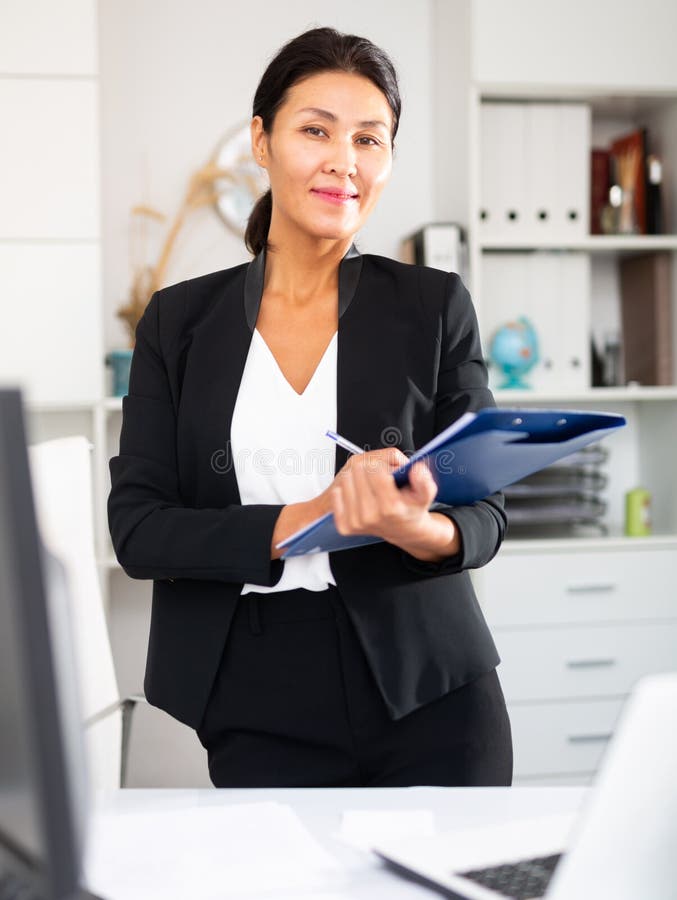 Portrait of Female Manager with Folder of Documents in Office Stock ...